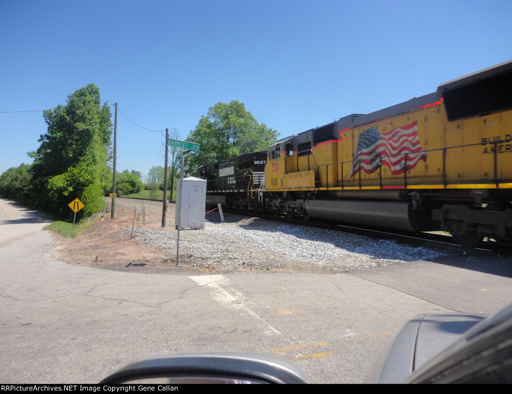 NS 9627 and UP 5111 cross Barrett Road in Lula, Ga.
